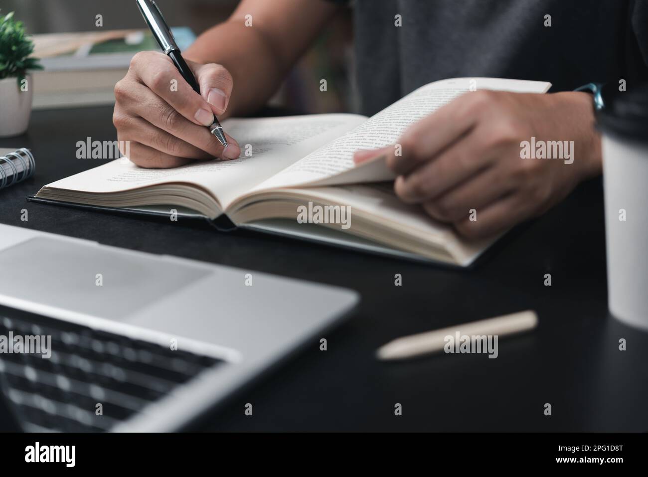 learning online class by using laptop computer and writing notebook at ...