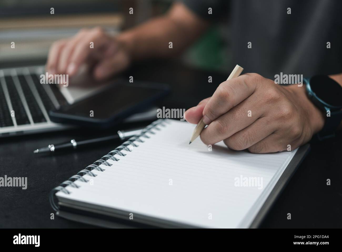 learning online class by using laptop computer and writing notebook at ...