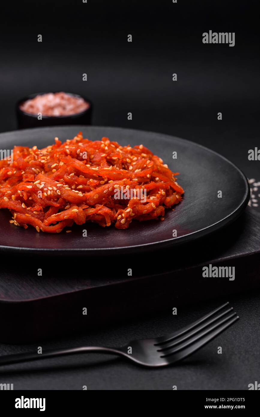 Dried squid chopped into slices and seasoned with sesame seeds and ...