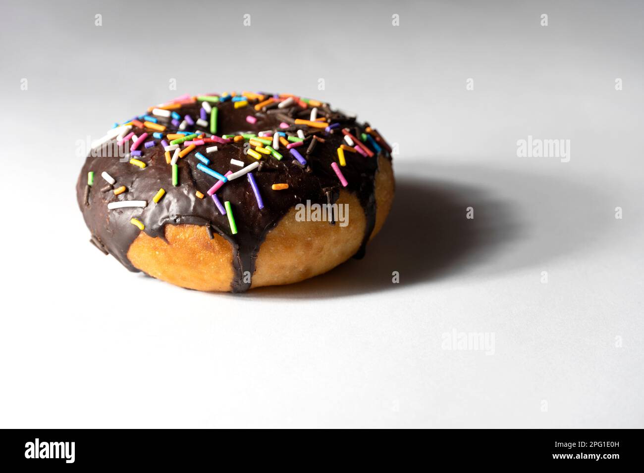 Colourful donuts on white background Stock Photo - Alamy