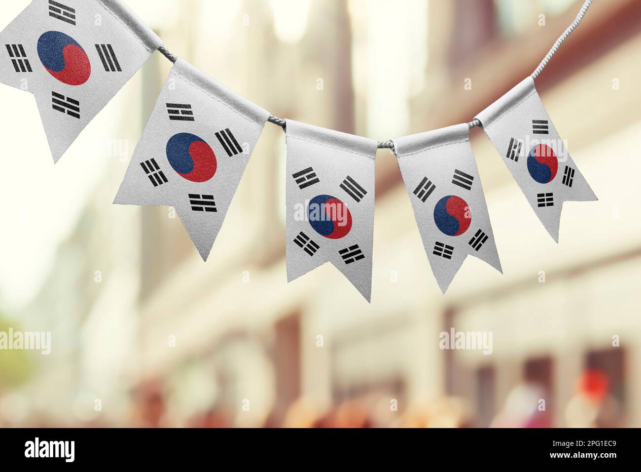A garland of South Korean national flags on an abstract blurred ...