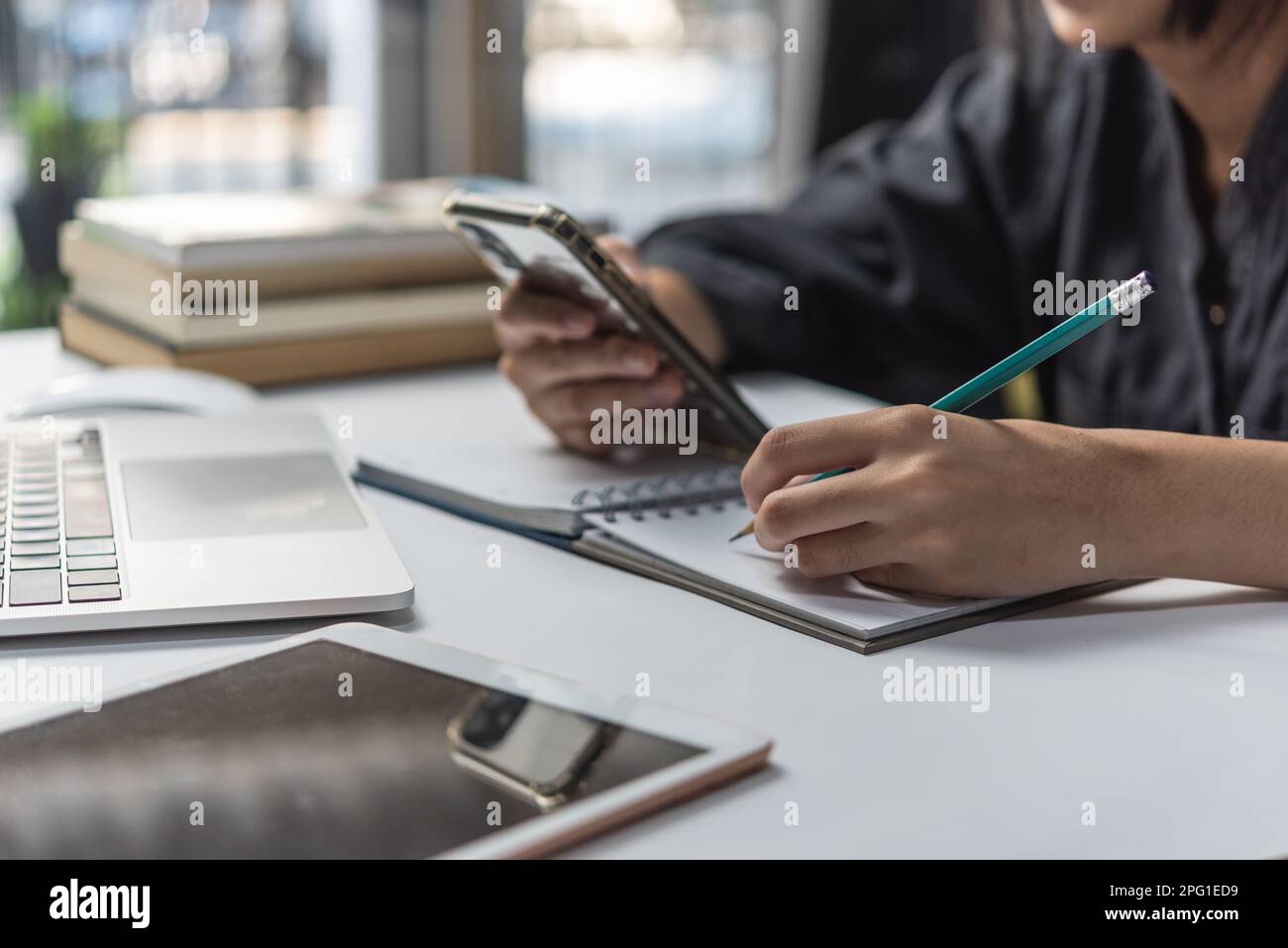 Woman hands with pen writing on notebook in the office.learning ...