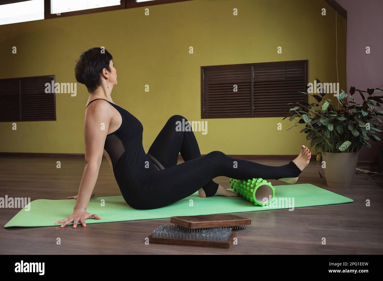 A woman leading a healthy lifestyle and practicing yoga, performs ...