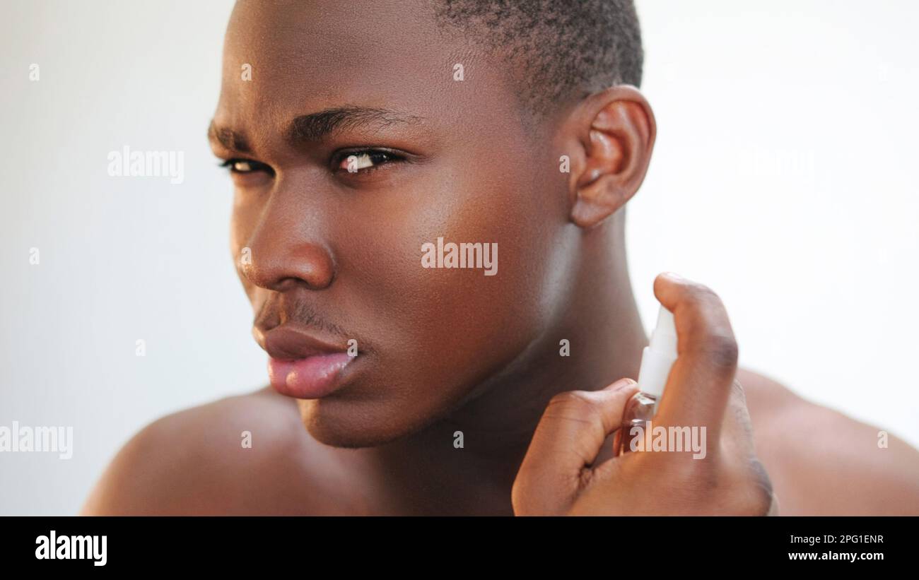 Aftershave spray skin care portrait man clean face Stock Photo - Alamy