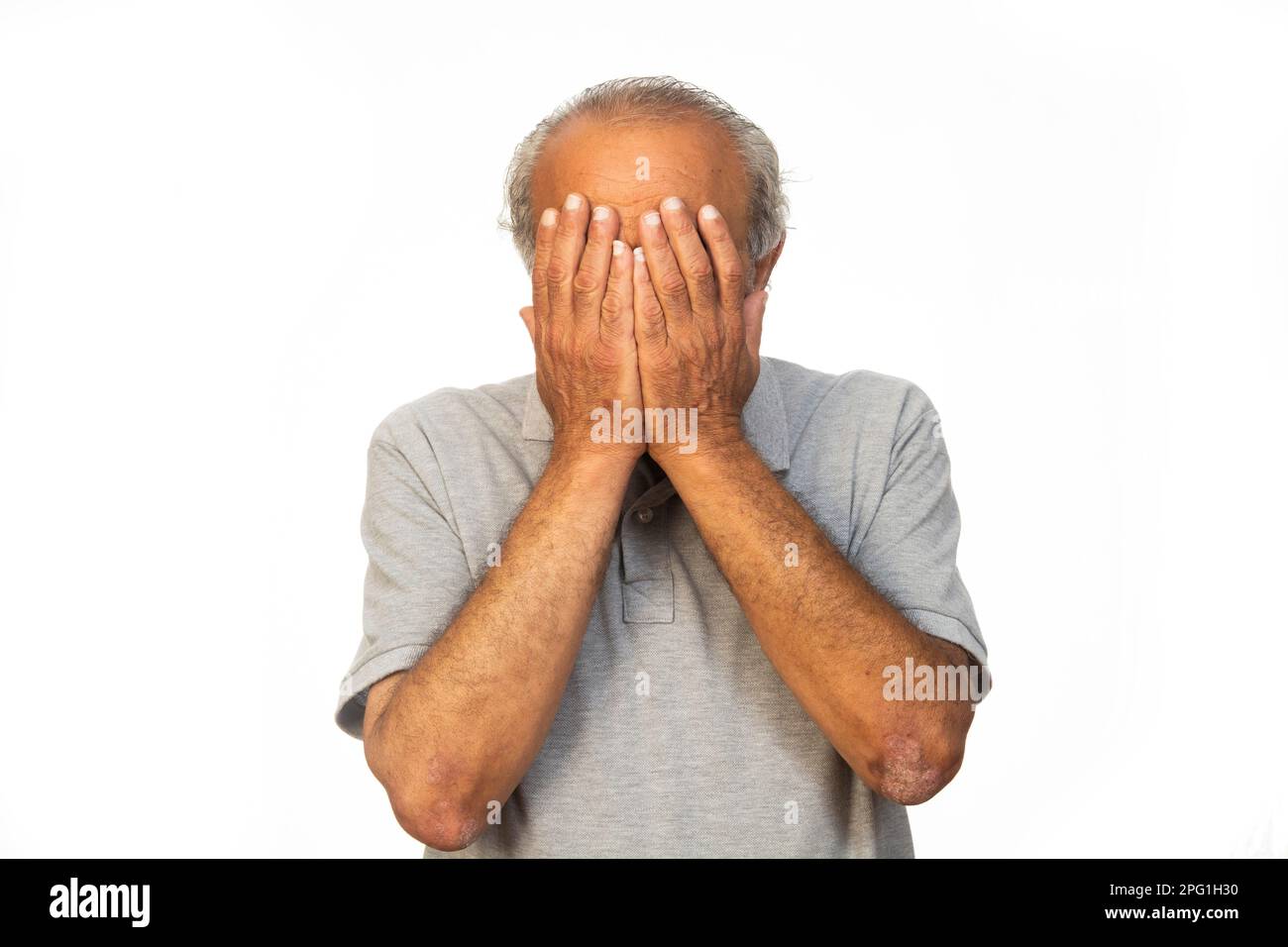Old man haiding his face with hands against white background Stock ...