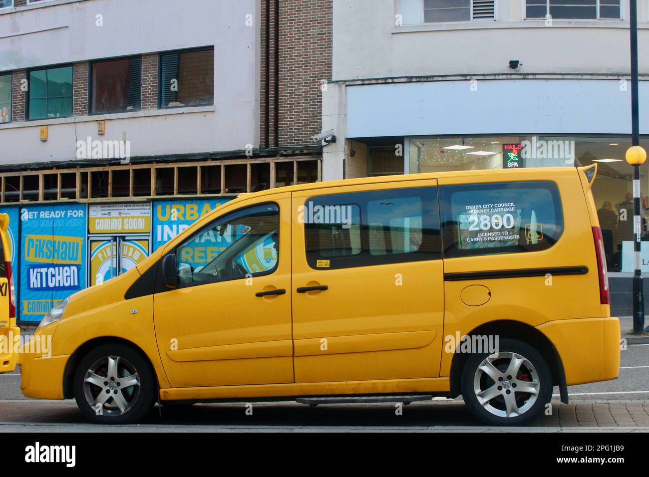 yellow taxi in derby city centre england uk Stock Photo - Alamy