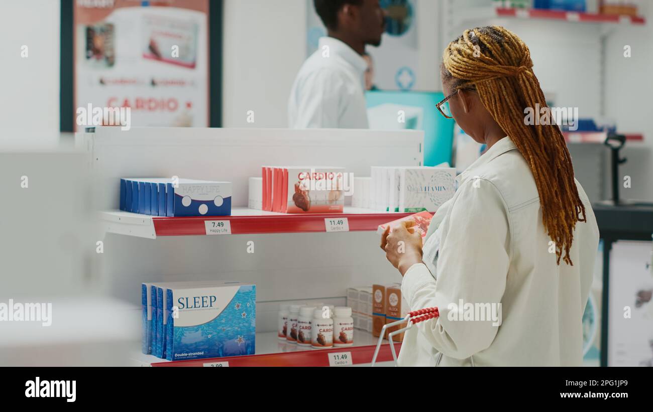 Black woman reading leaflet hi-res stock photography and images - Alamy