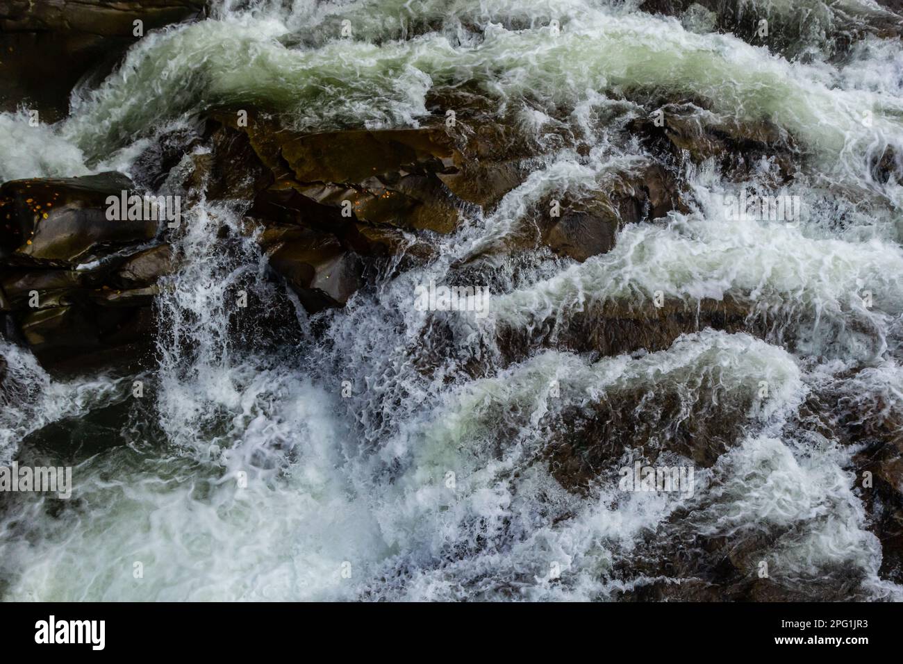 The stream of water flowing over rocks.Image close-up Stock Photo - Alamy