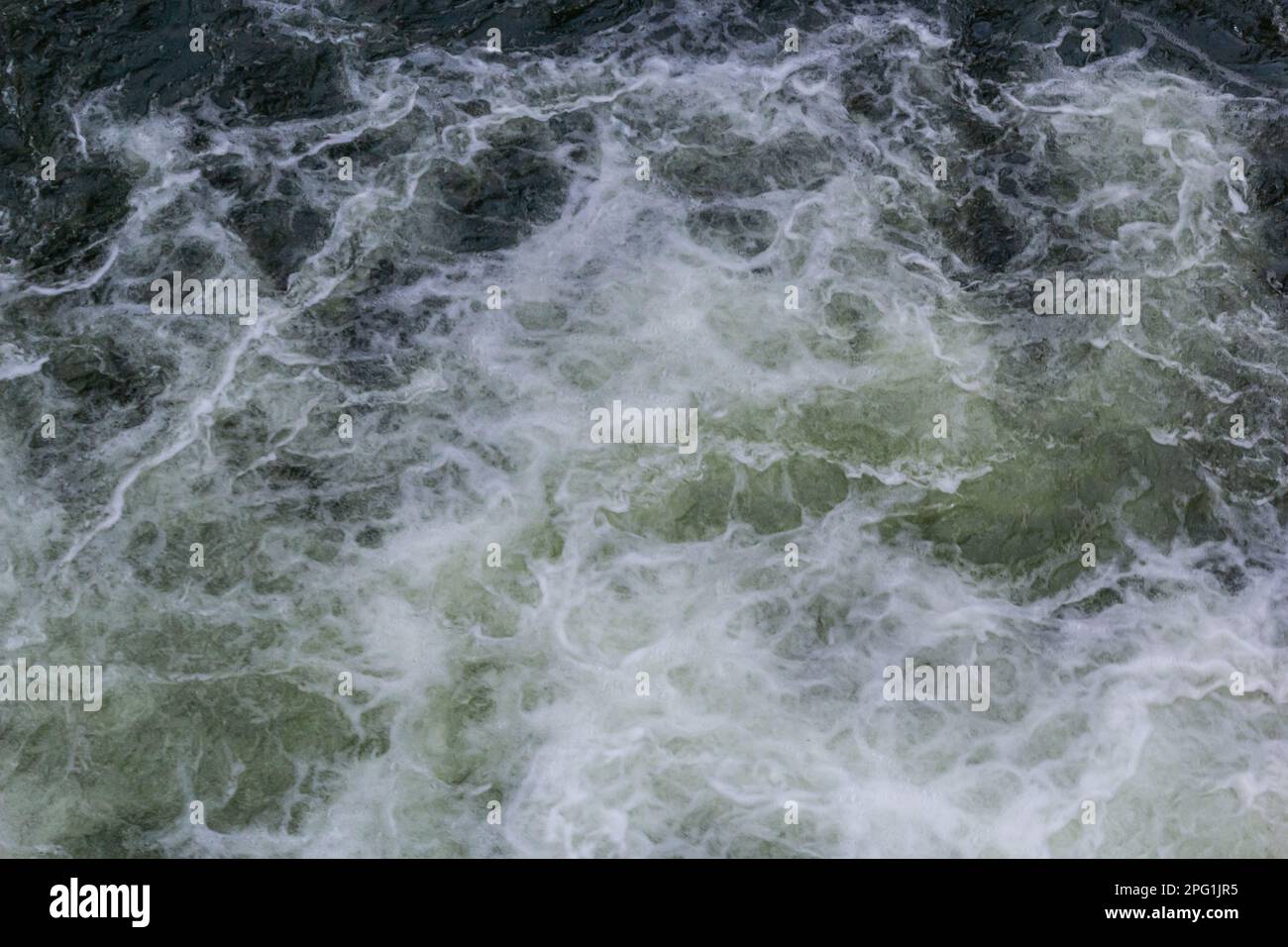 rapids of mountain rivers with fast water and large rocky boulders ...