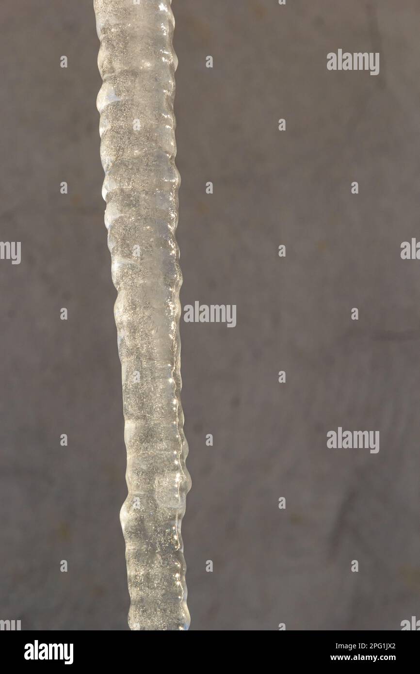 Sharp icicles and melted snow hanging from eaves of roof. Beautiful ...