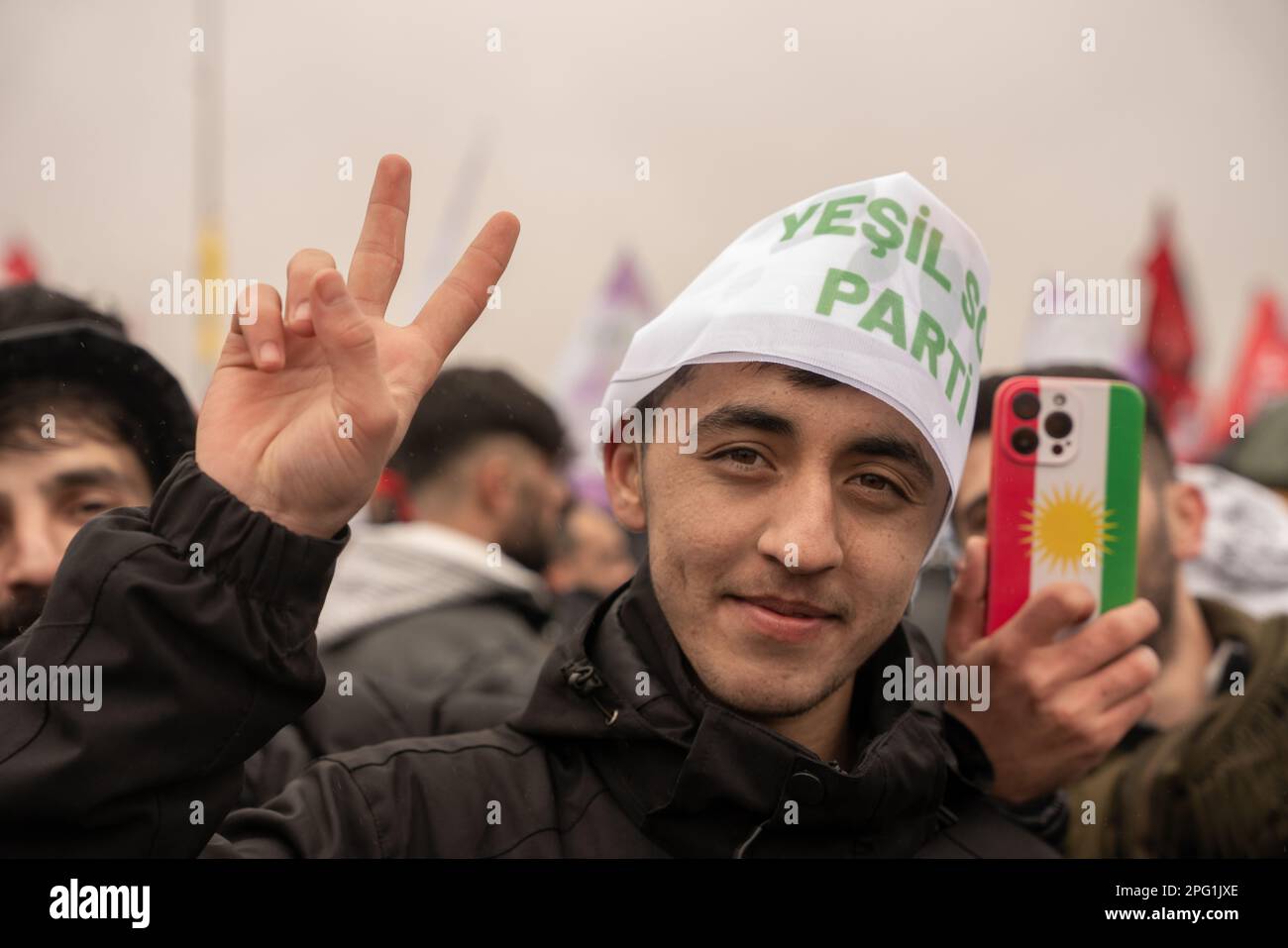 Istanbul, Turkey. 19th Jan 2022. A man wears a flag of the Yeşil Sol ...