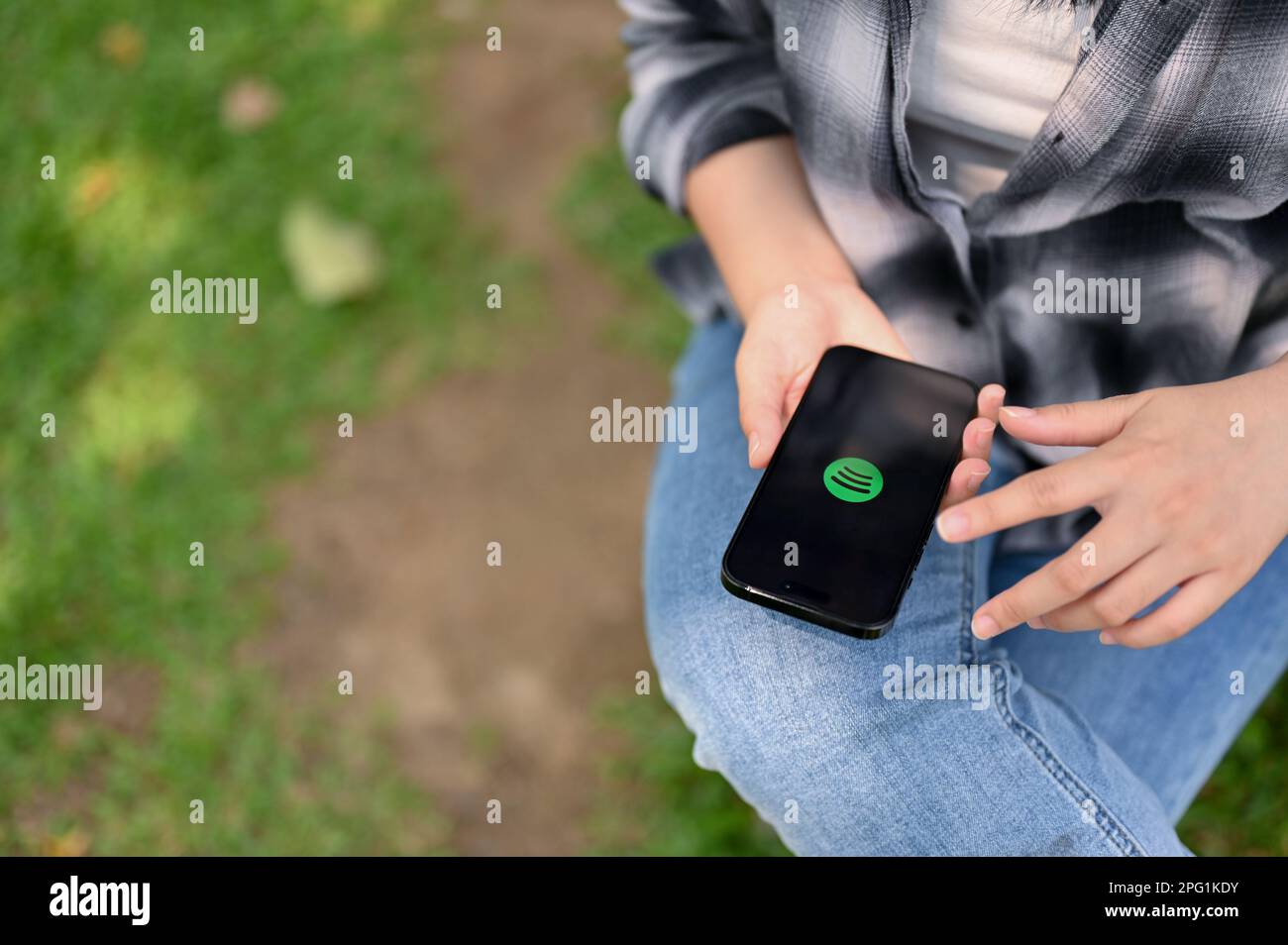 Chiang Mai, Thailand - March 16 2023: Top view of a woman using Spotify ...