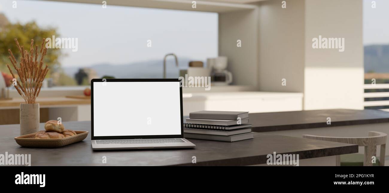 Laptop white screen mockup, book, bread basket and pampas grass in a ...