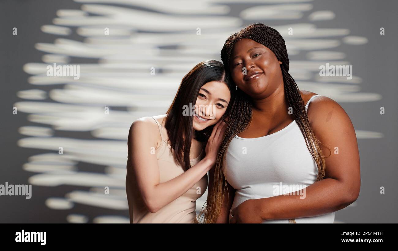 Diverse models feeling powerful posing for beauty ad, having natural ...