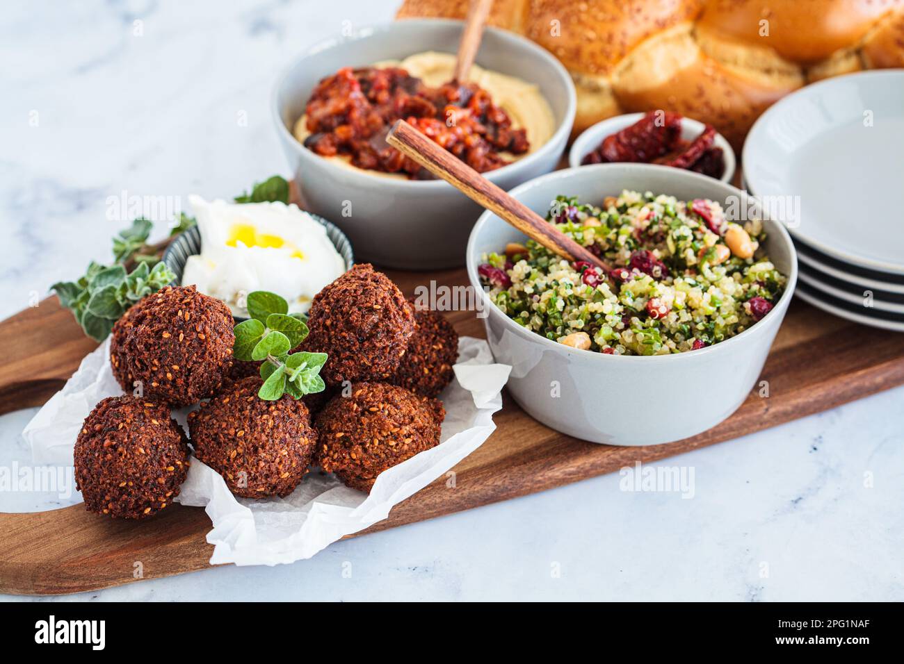 Traditional Shabbat table: challah bread, falafel, quinoa salad, hummus ...