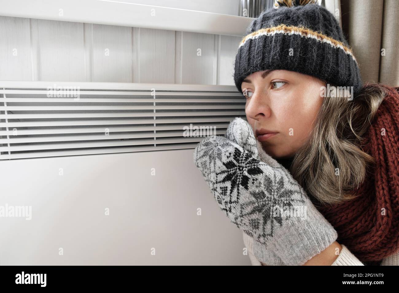 Young frozen woman wearing a sweater shaking and freezing for winter ...