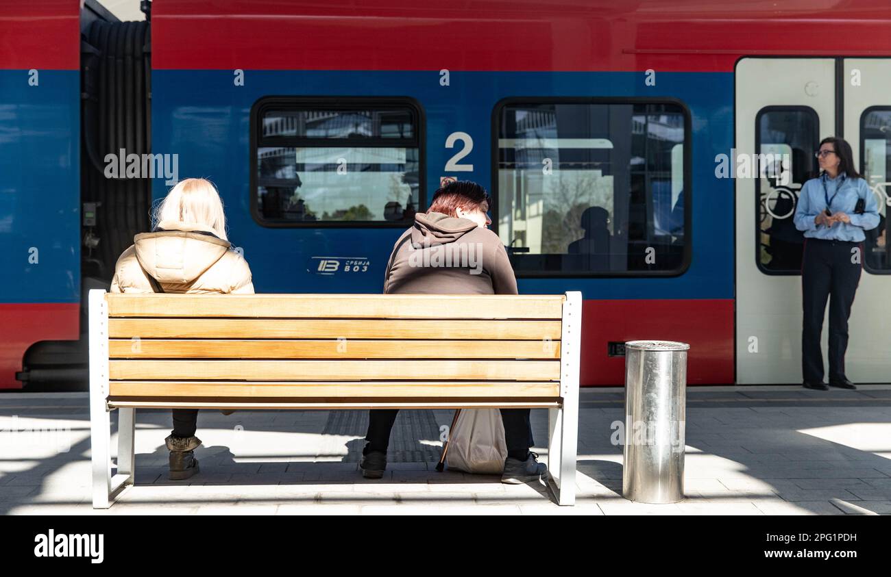 Novi Sad, Serbia. 19th Mar, 2023. Two women sit on a bench waiting for ...