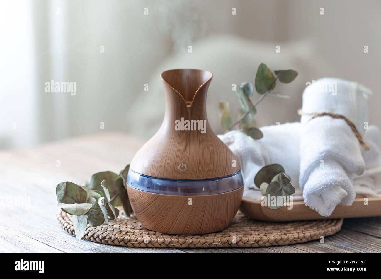 Spa composition with aroma oil diffuser lamp on a blurred background ...