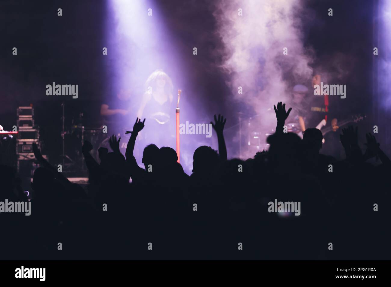 Crowd at concert - Cheering crowd in front of bright colorful stage ...
