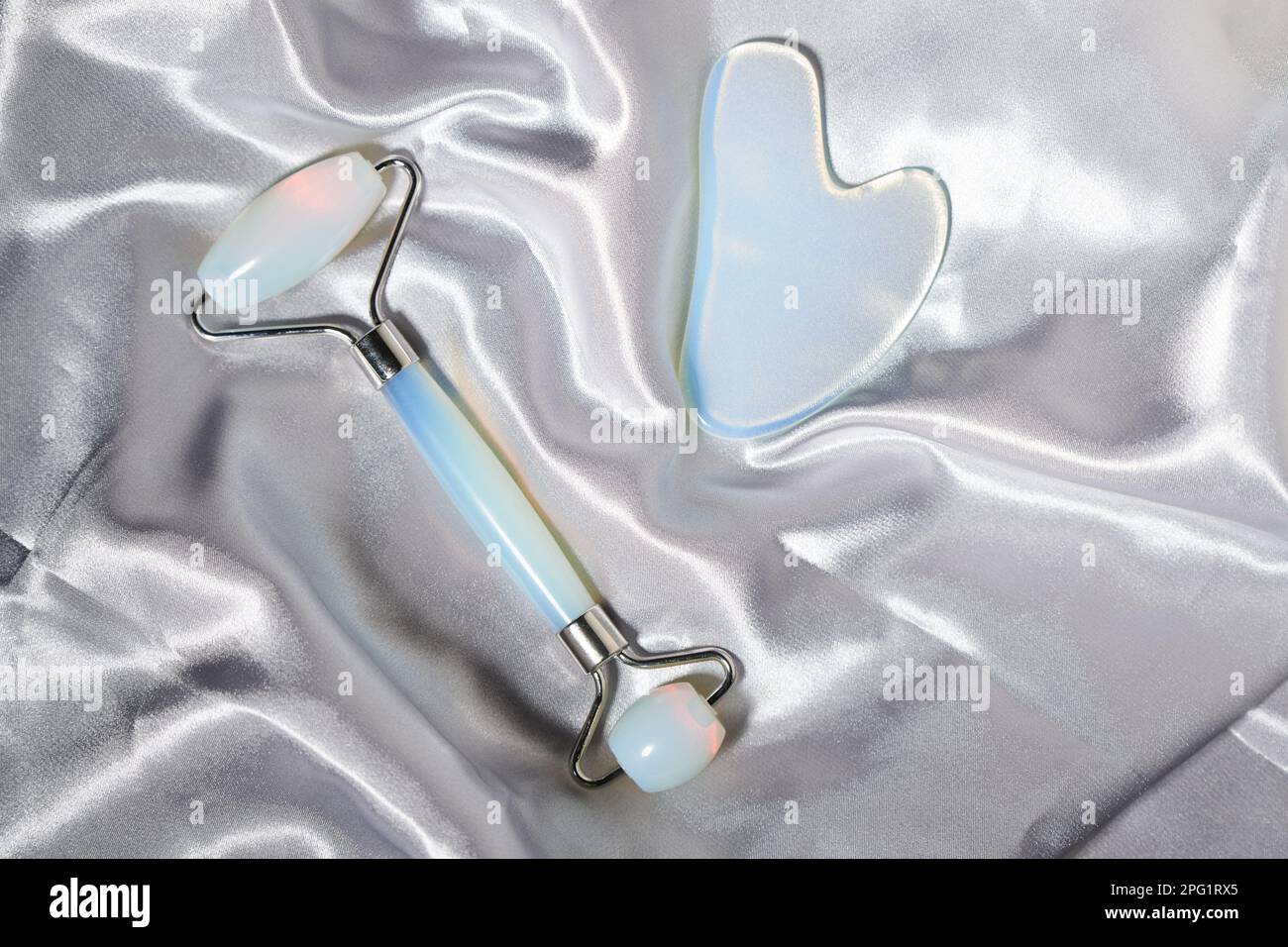 Blue jade face roller and Gua Sha scraping for beauty facial massage ...