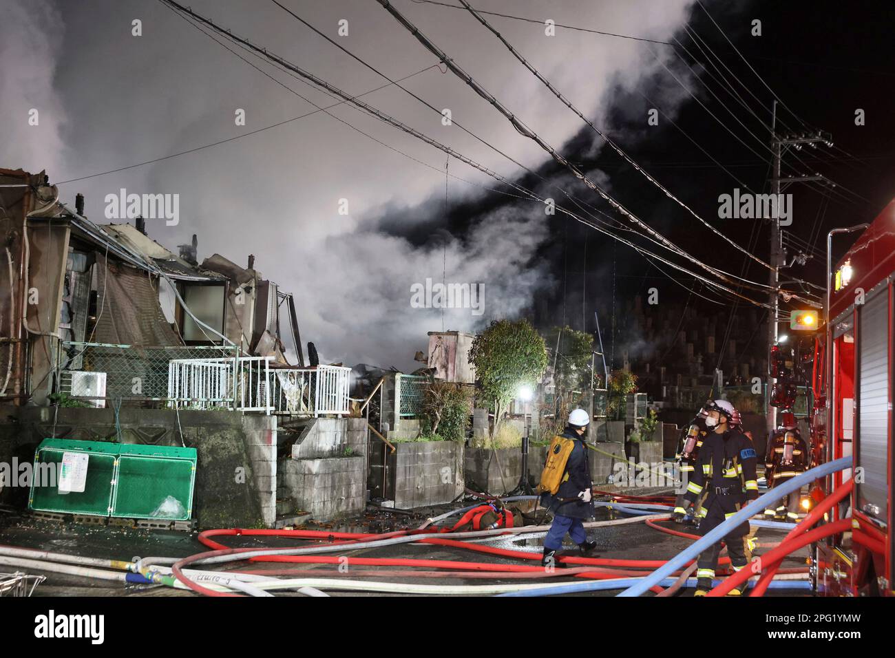 A fire breaks out from a two-story wooden row house and spreads to ...