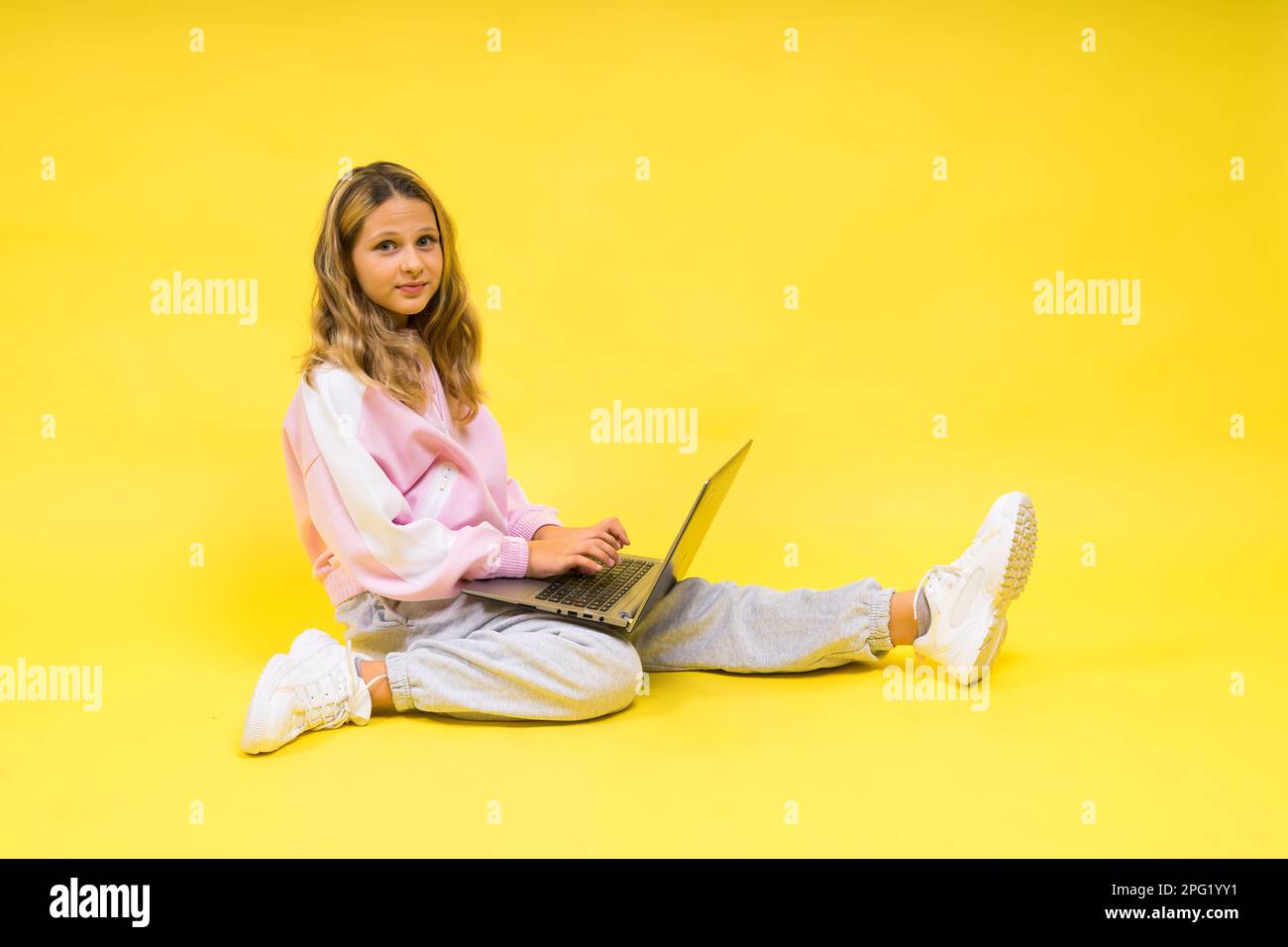 Positive kid sit with a laptop read homework wear casual style cloth ...