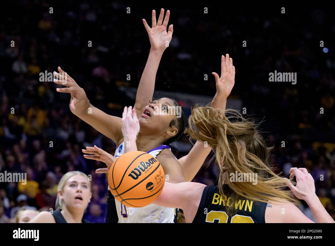 The right fake eyelash of LSU forward Angel Reese, center, comes off as ...