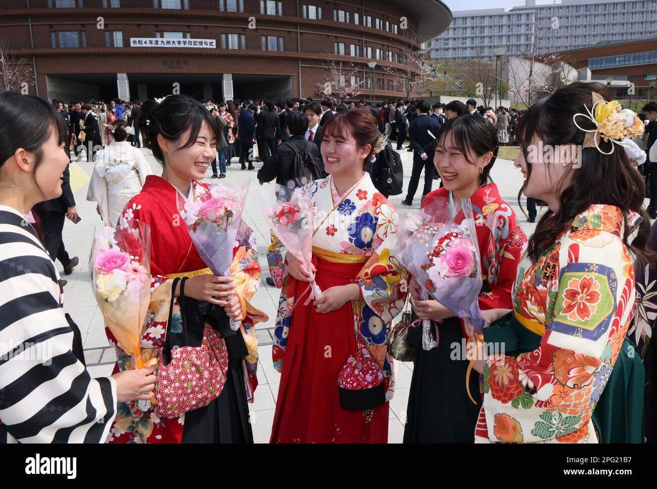 Students take pictures during the graduation ceremony at Kyushu ...