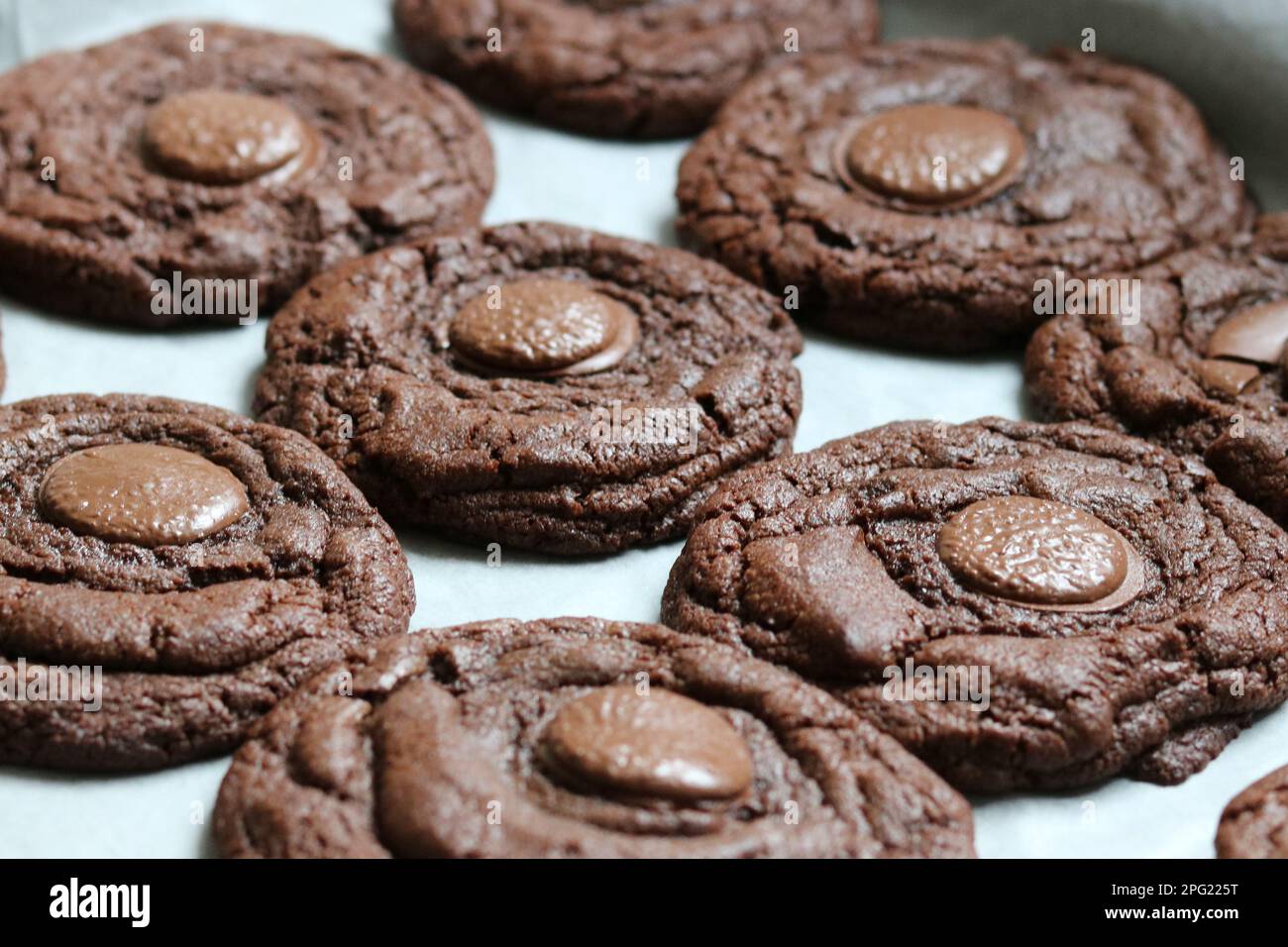 Full frame image of chocolate cookies with melted chocolate buttons on ...
