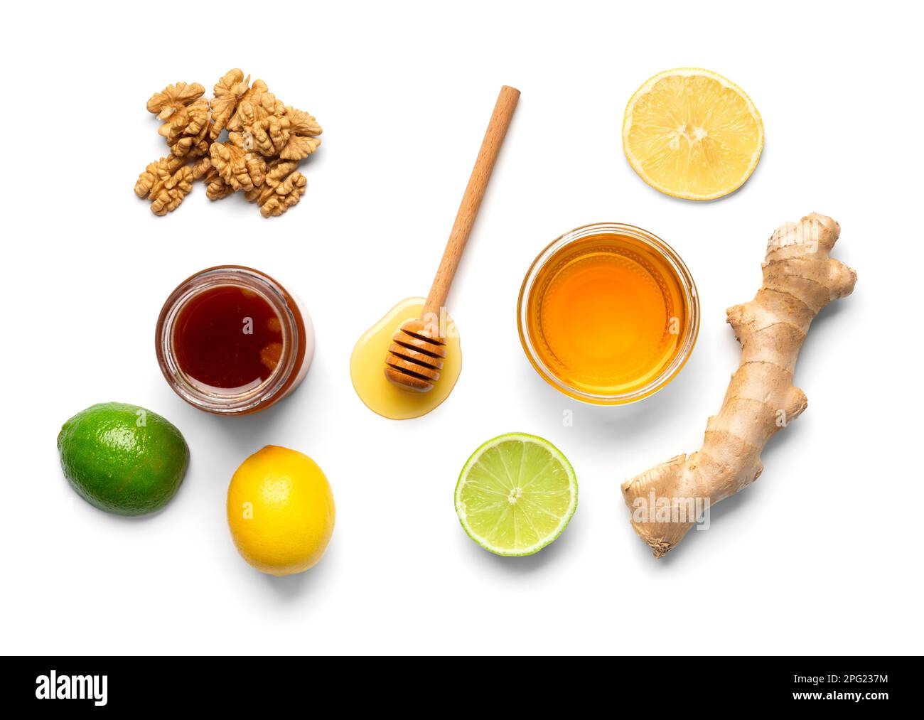 Honey, nuts, ginger, lemon, lime and dipper on isolation Stock Photo ...