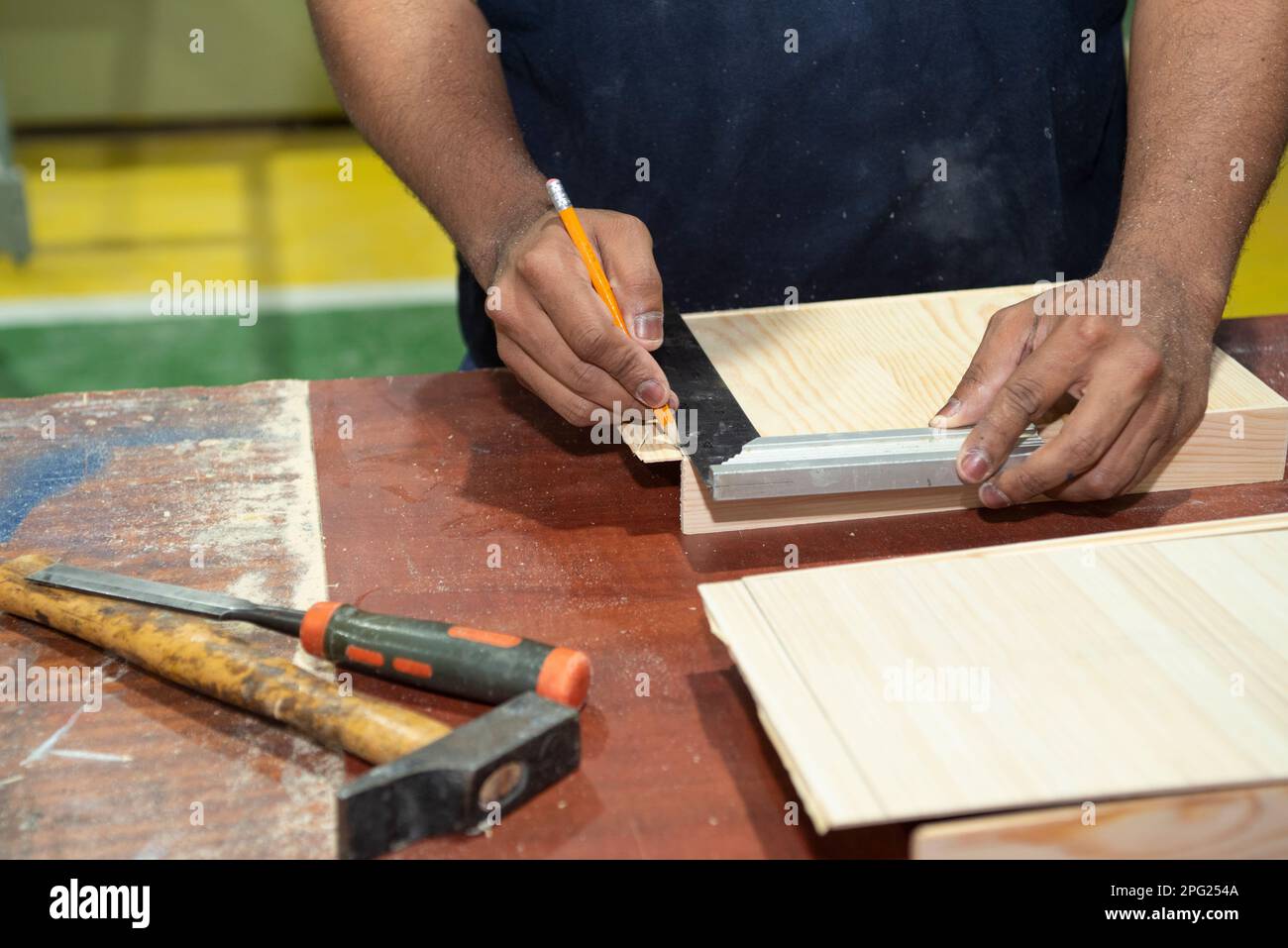 Hands of a carpenter man taking measurements and marking them Stock ...
