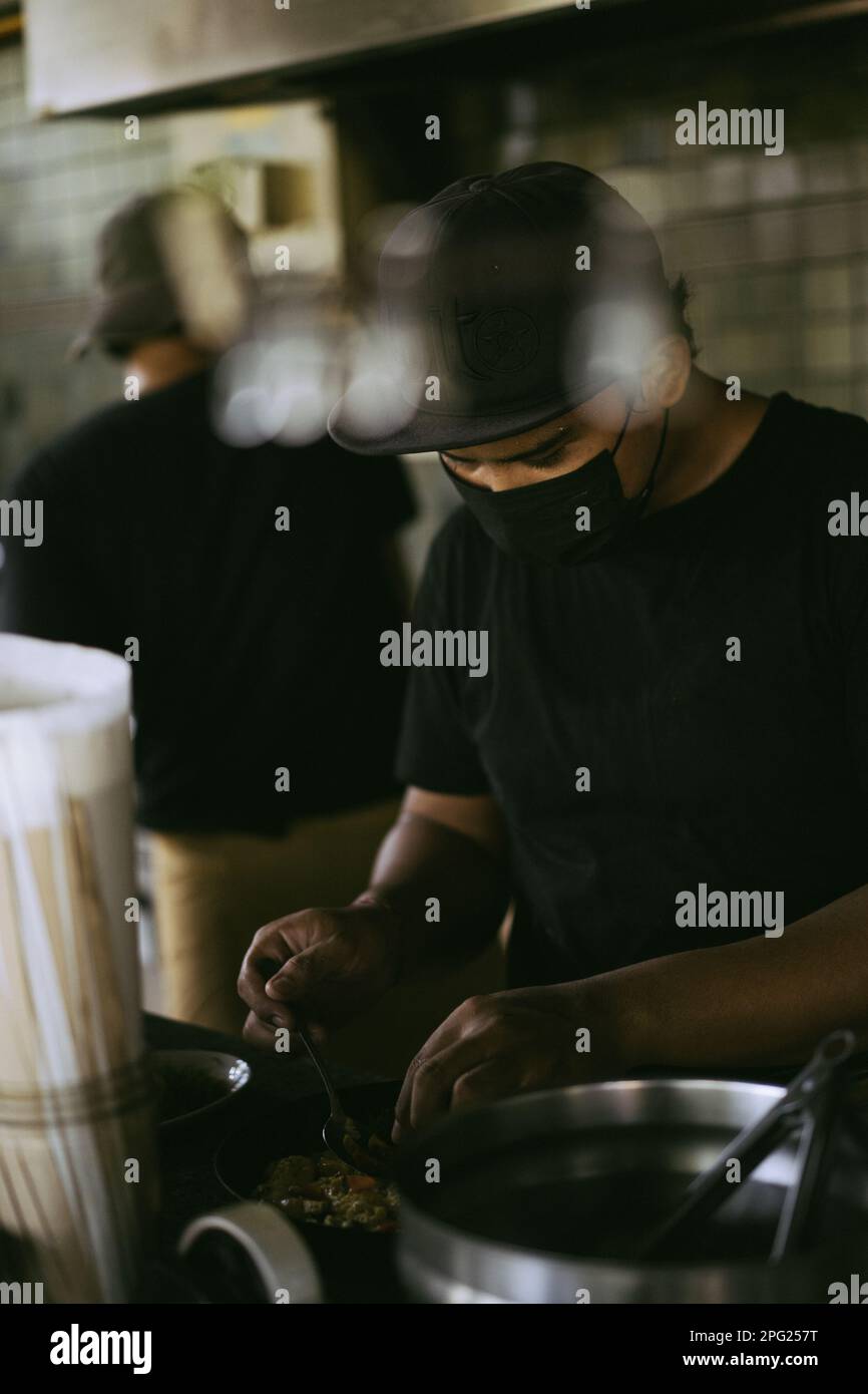 Asian man cooking in the restaurant kitchen Stock Photo - Alamy