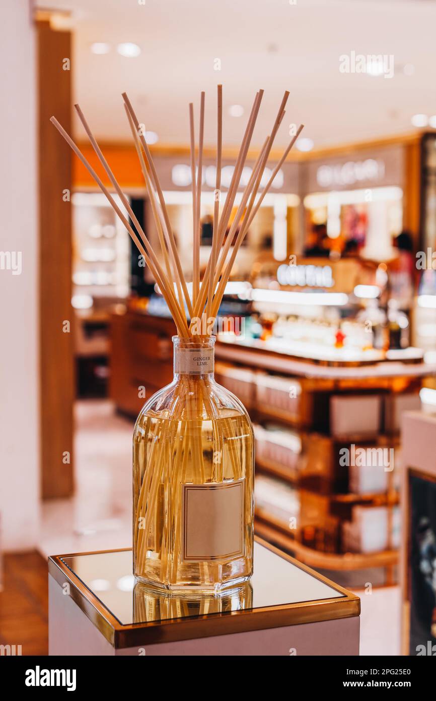 Golden glass bottle with wood stick aroma diffusers on mirror stand in the shopping mall Home ...