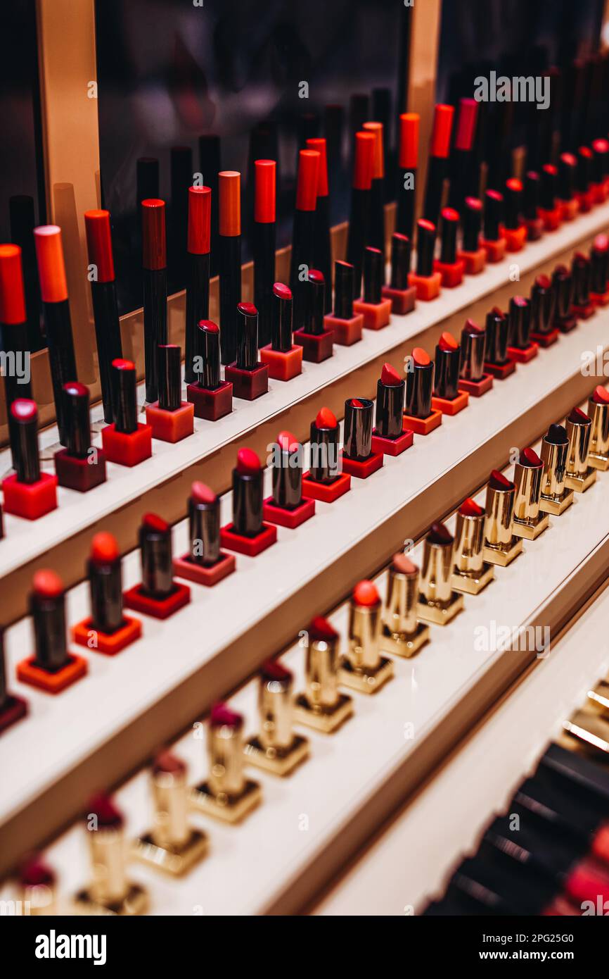 Mockup of pink red glossy lipsticks on a stand. Background for branding ...