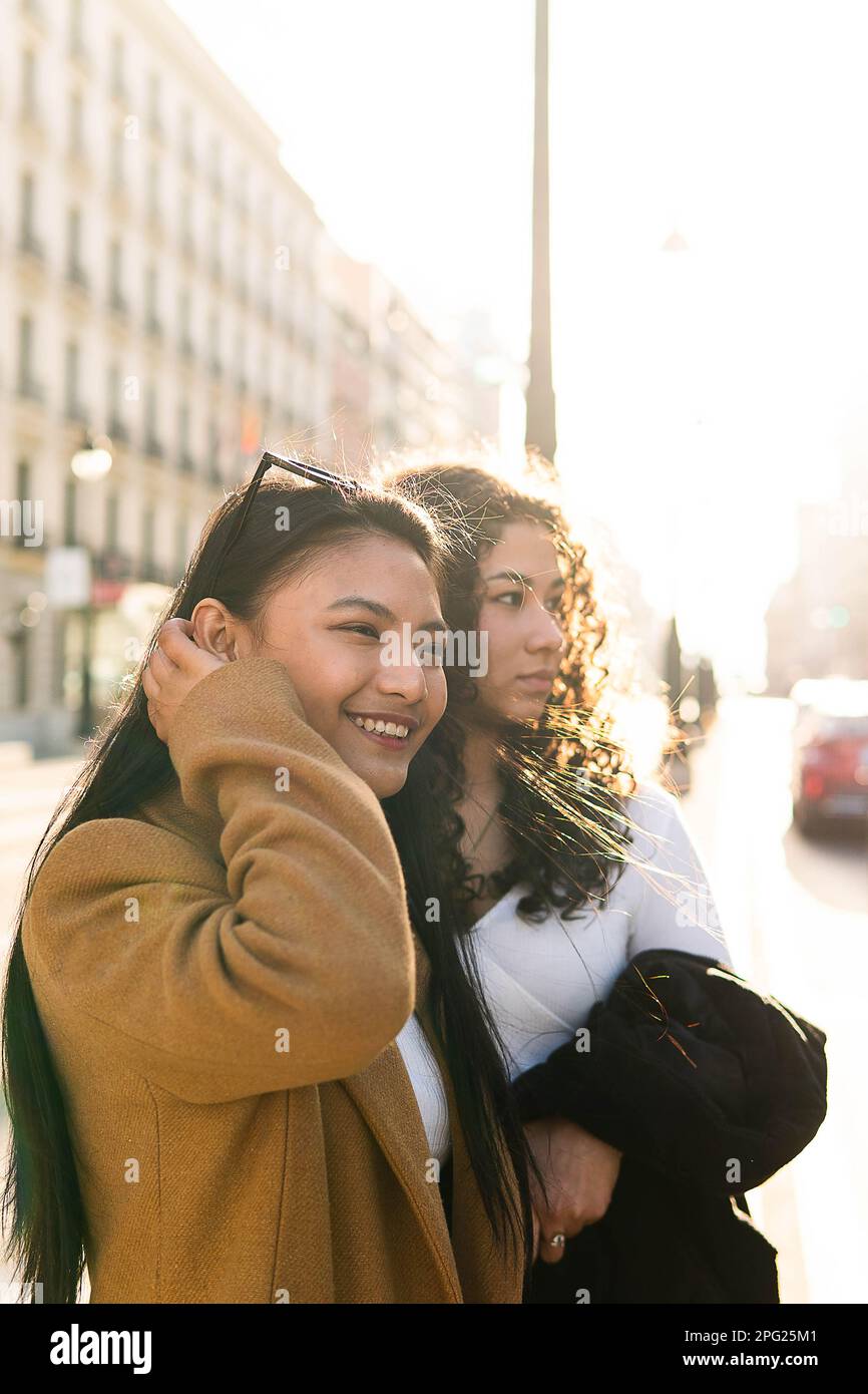 Stock photo of a profile shot of two friends standing Stock Photo - Alamy
