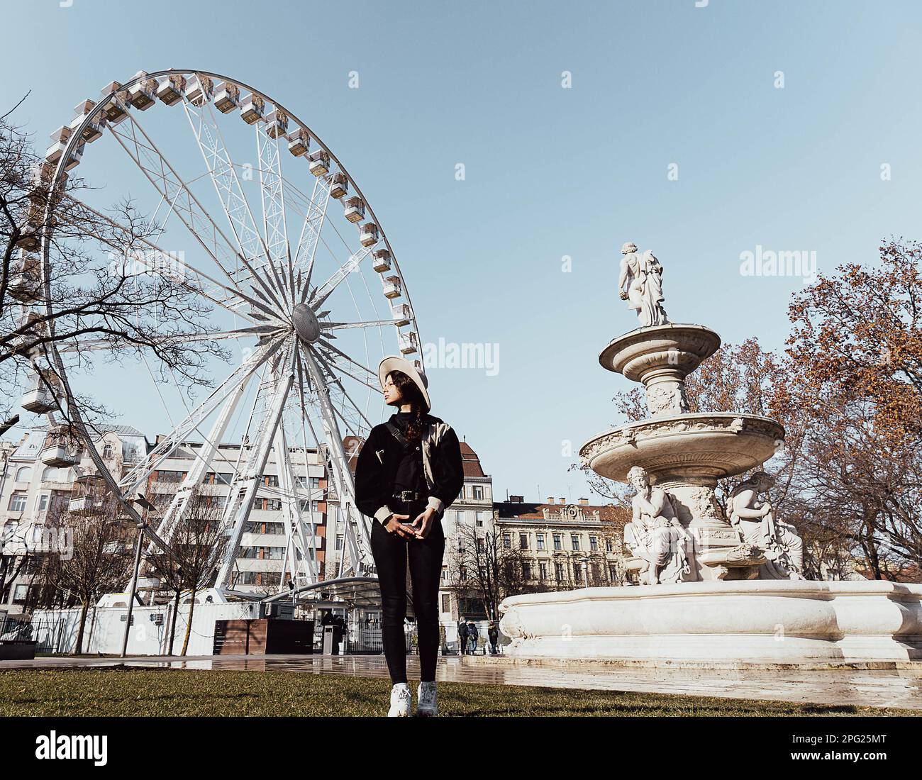 stock photo of girl with hat against Ferris Wheel of Budapest Stock ...