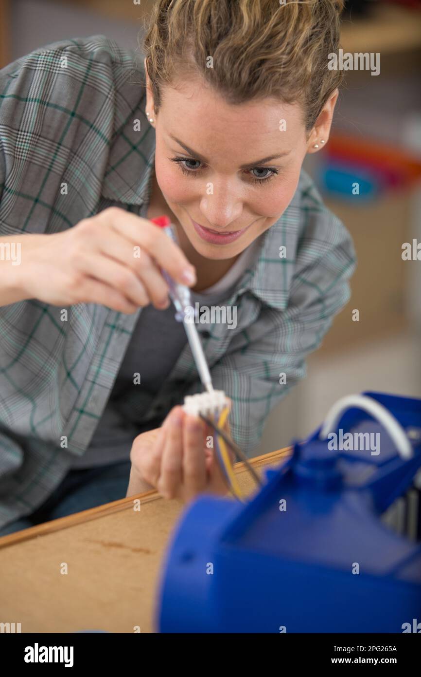 Female electrician fixing socket hi-res stock photography and images ...
