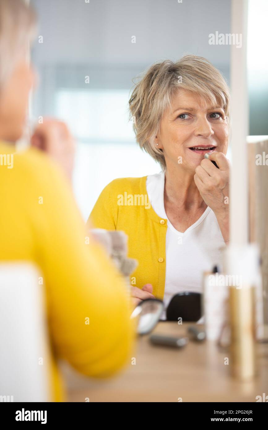 Mature woman applying foundation hi-res stock photography and images ...