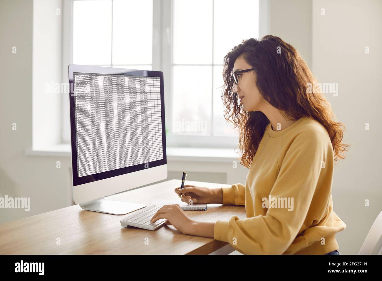Accountant lady sitting at office desk and working with digital ...