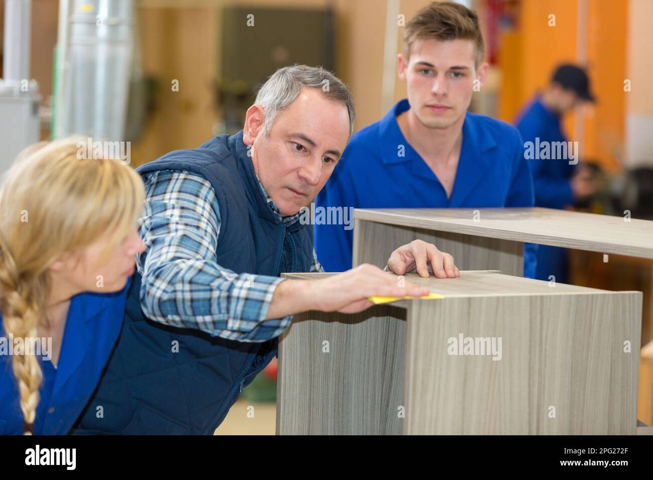 teacher with students in workshop Stock Photo - Alamy
