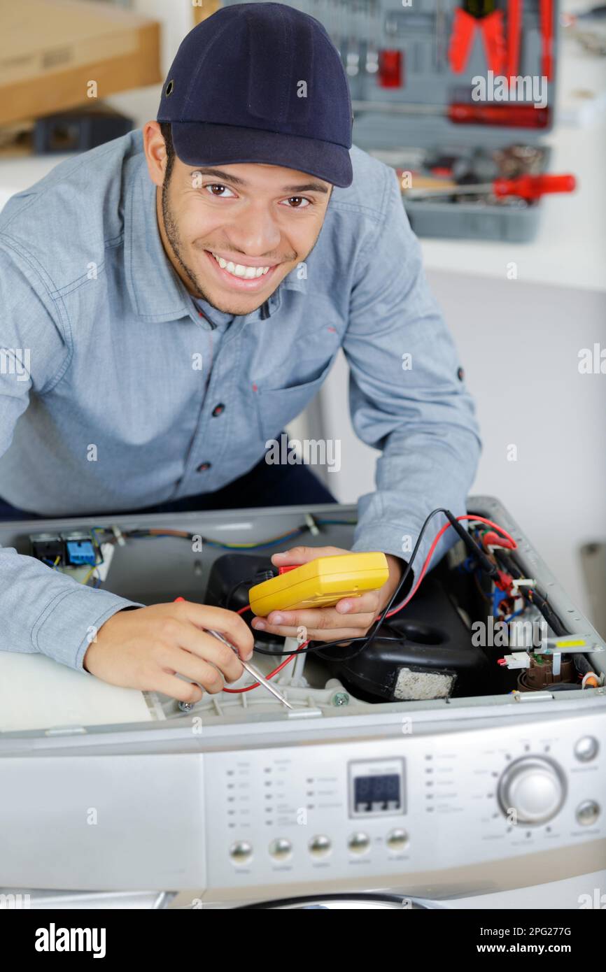 young happy electrician uses a multimeter Stock Photo - Alamy