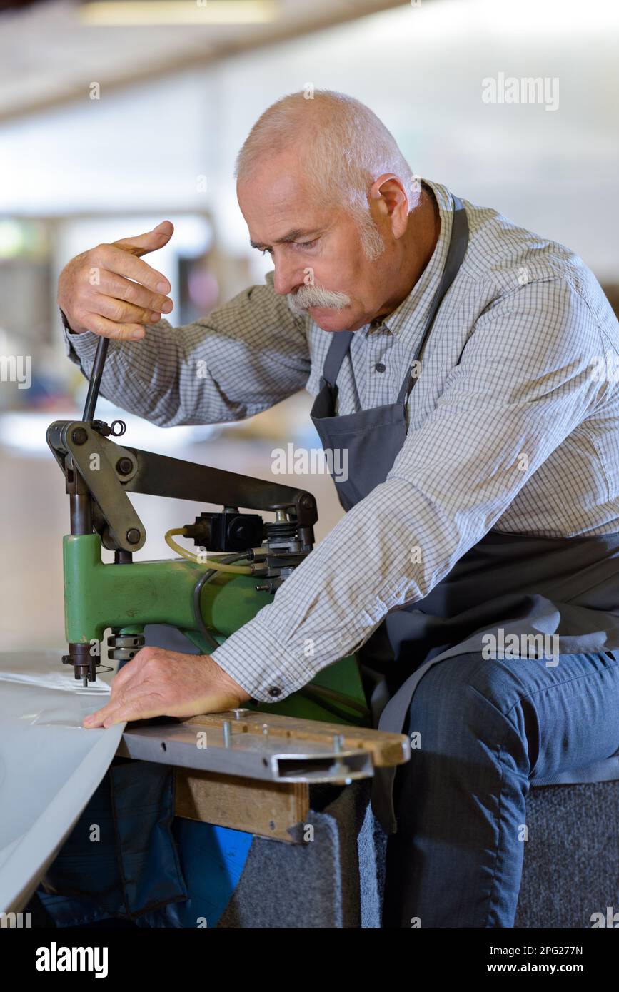 worker using industrial puncher to make hole Stock Photo - Alamy