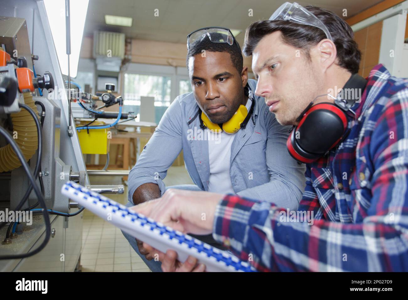 two framers working on designs in their workshop Stock Photo - Alamy