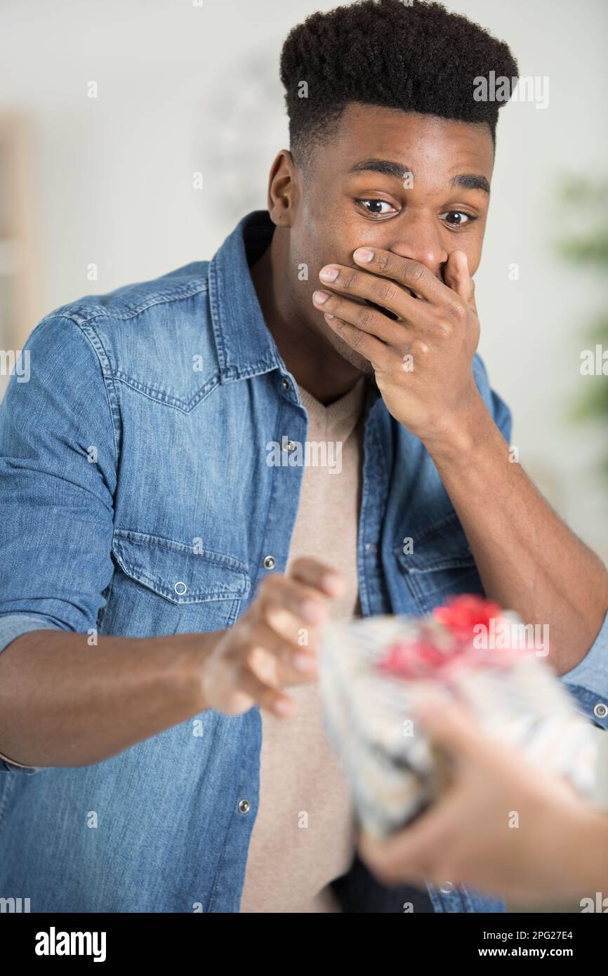 astonished man receiving an unexpected gift Stock Photo - Alamy