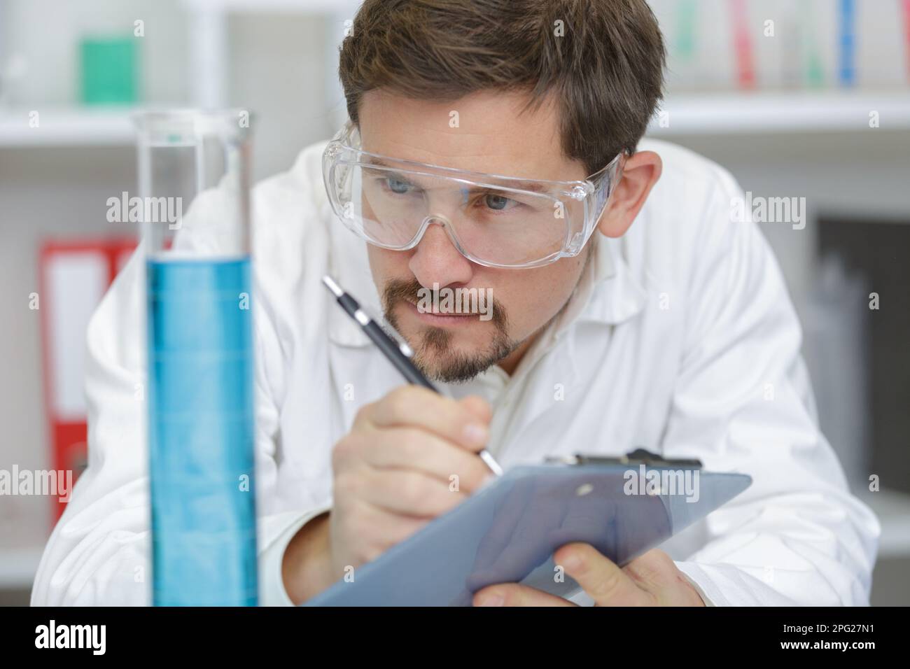 Lab technician doing microscope sample hi-res stock photography and ...