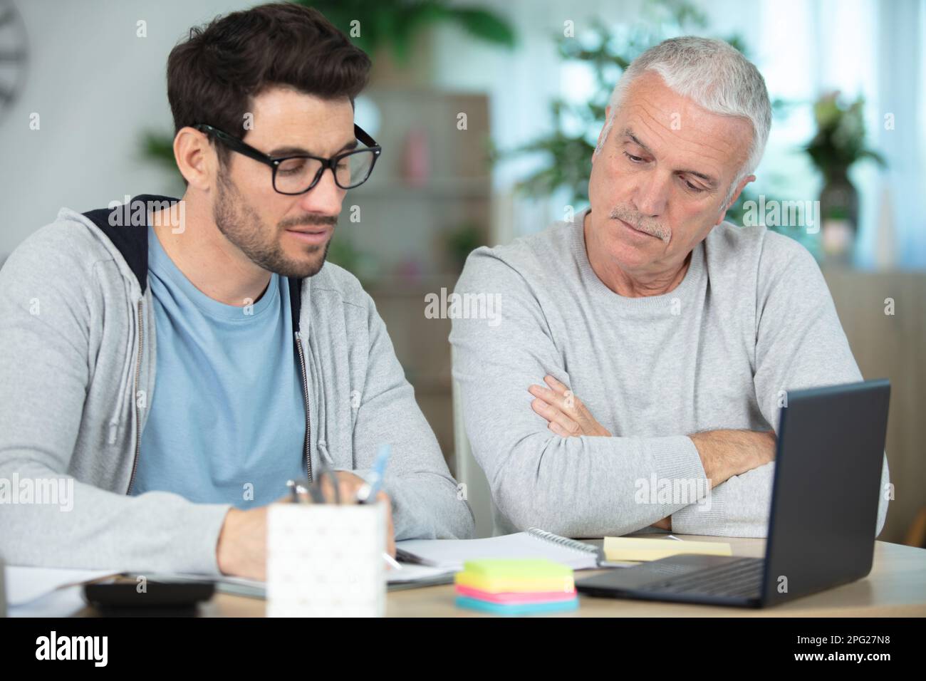 adult father and son discuss acount and financial Stock Photo - Alamy
