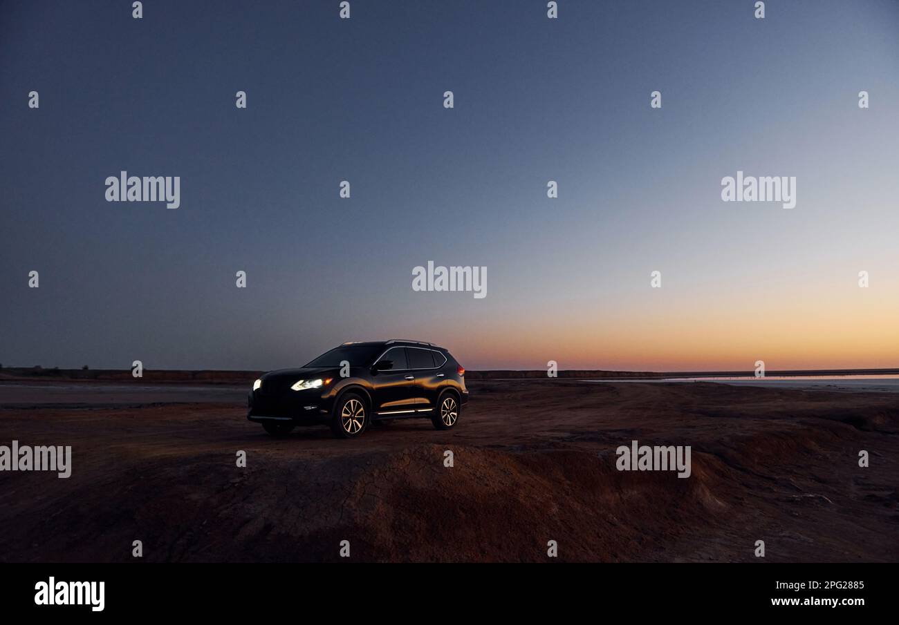 Distant view of modern black automobile that is on the coast Stock ...