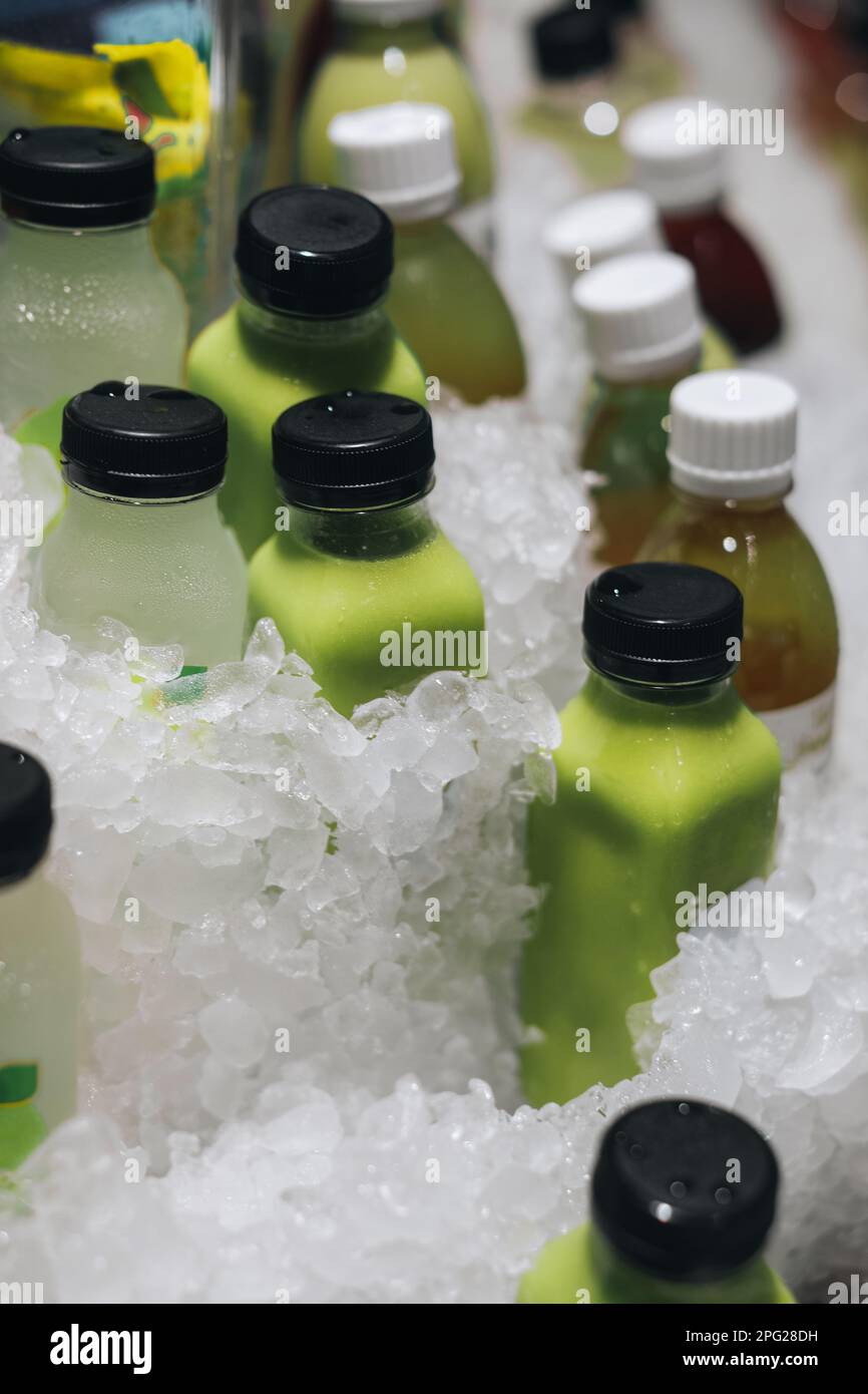 Plastic bottles with fresh avocado juice in ice Stock Photo - Alamy
