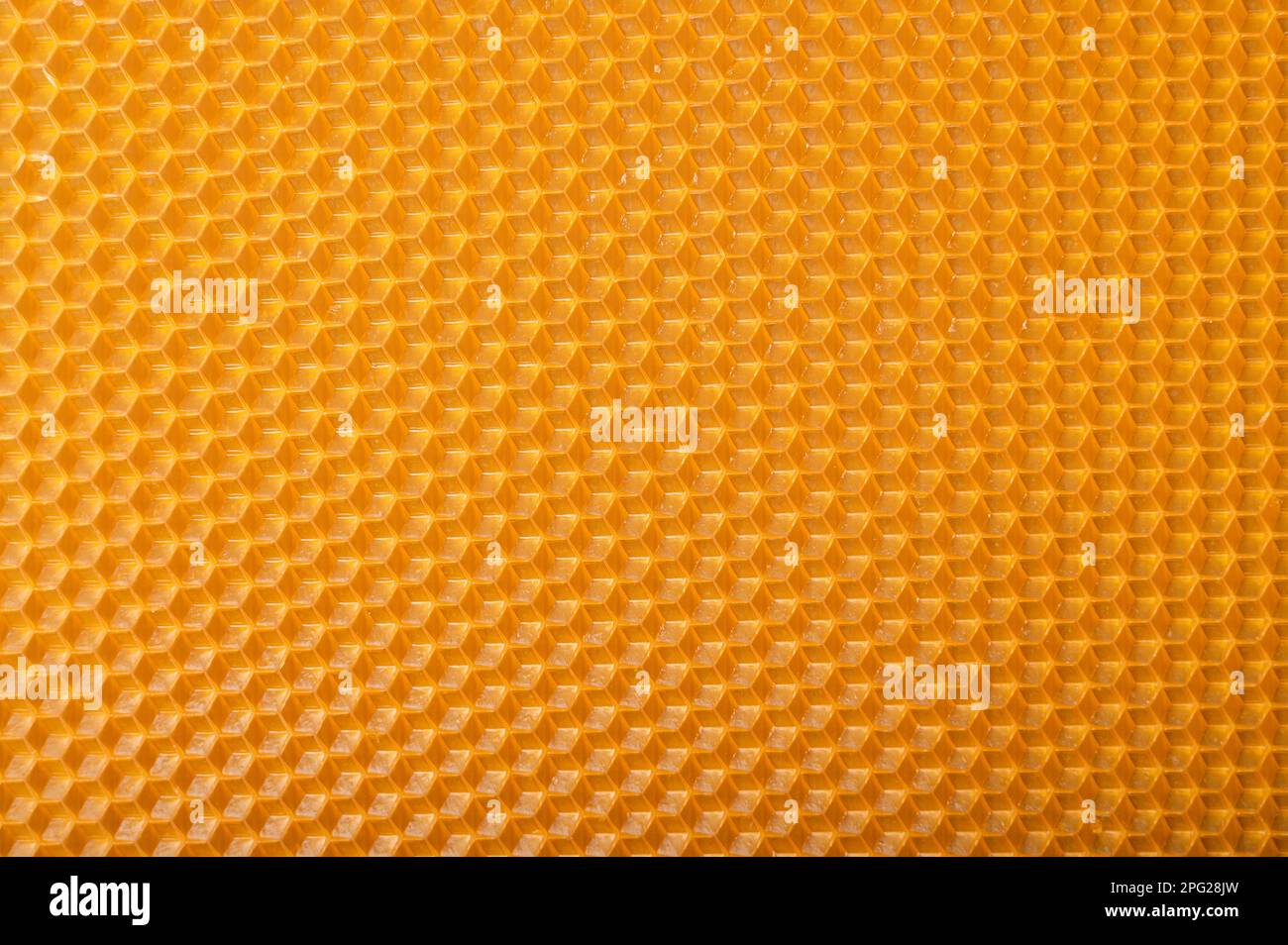 Beeswax honeycomb candle sheet close up background Stock Photo - Alamy
