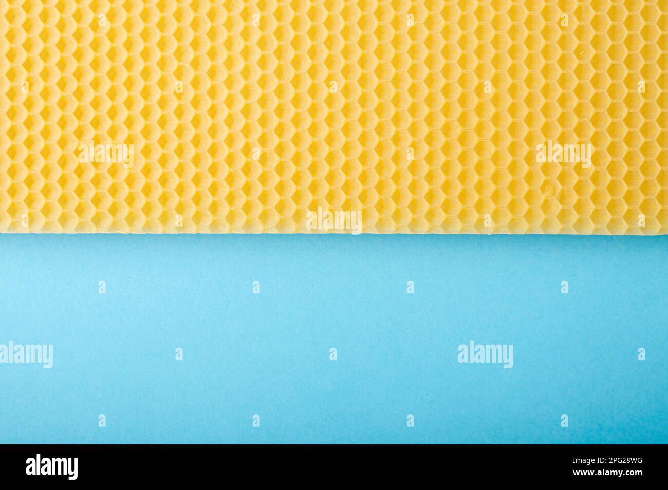 Beeswax honeycomb candle sheets on blue background Stock Photo - Alamy